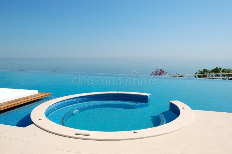 Infinity Swimming Pool with Jacuzzi by Beach Stock Photo - Image of ...