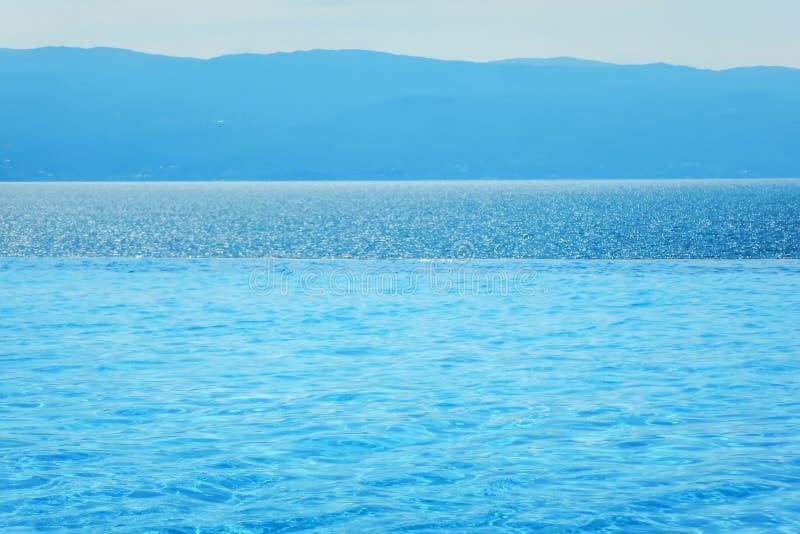 Infinity Swimming Pool with Sea and Mountain View Stock Photo - Image ...