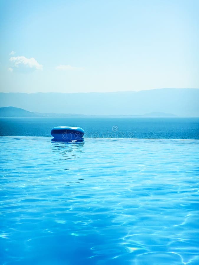 Infinity Swimming Pool with Sea and Mountain View Stock Photo - Image ...