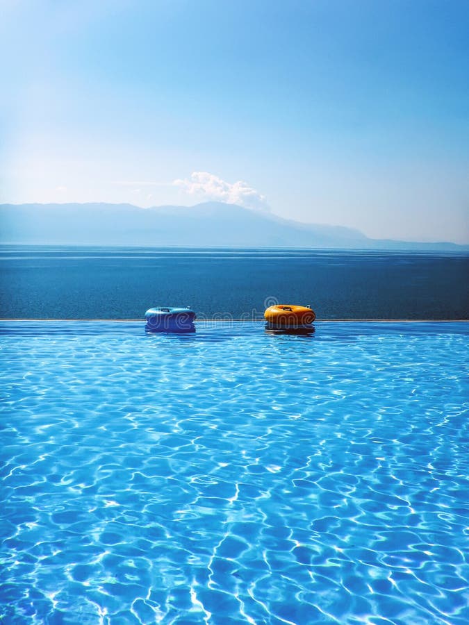 Infinity Swimming Pool with Sea and Mountain View Stock Image - Image ...