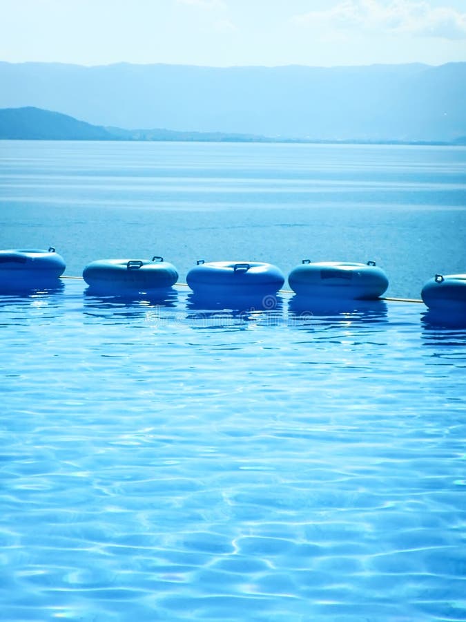 Infinity Swimming Pool with Sea and Mountain View Stock Photo - Image ...
