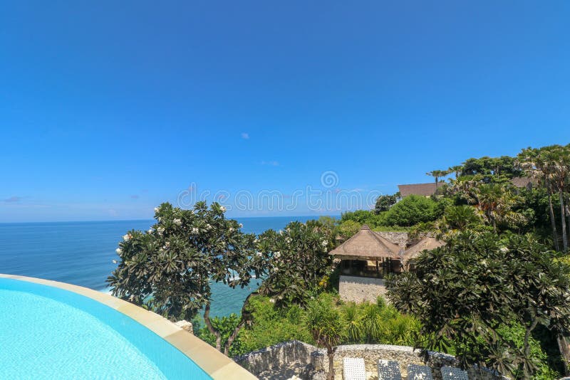 Infinity Swimming Pool with Sea and Ocean View on Blue Sky Background ...