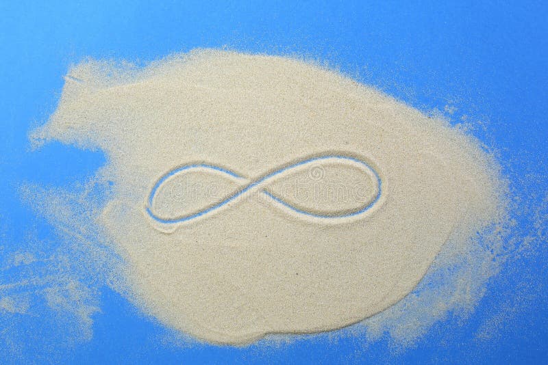 Infinity Symbol Written in Sand on a Blue Background. Stock Image ...