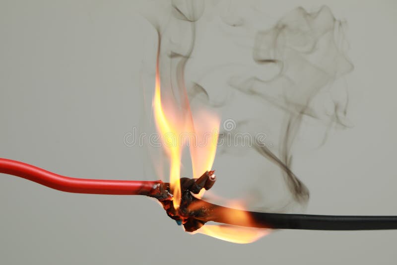 Inflamed Red Wire on Grey Background, Closeup. Electrical Short Circuit ...