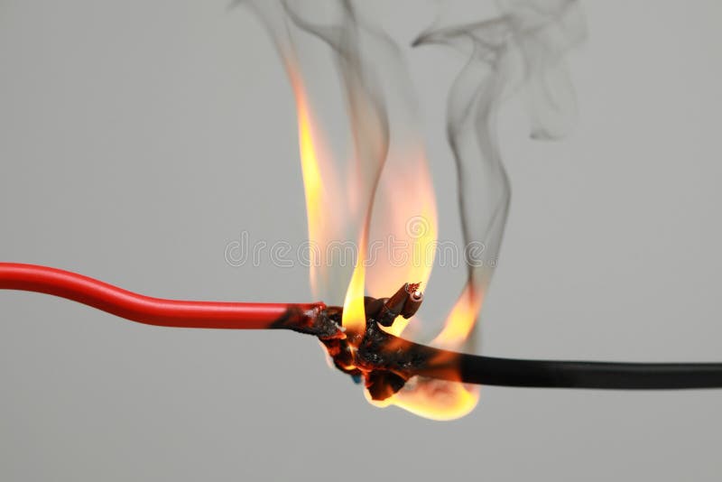 Inflamed Red Wire on Grey Background, Closeup. Electrical Short Circuit ...