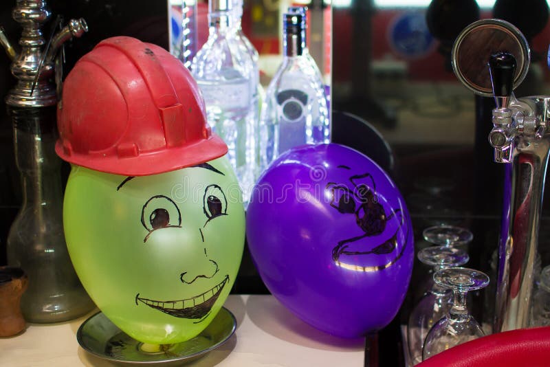 Inflatable Balls with Faces with a Helmet in the Bar Stock Photo ...