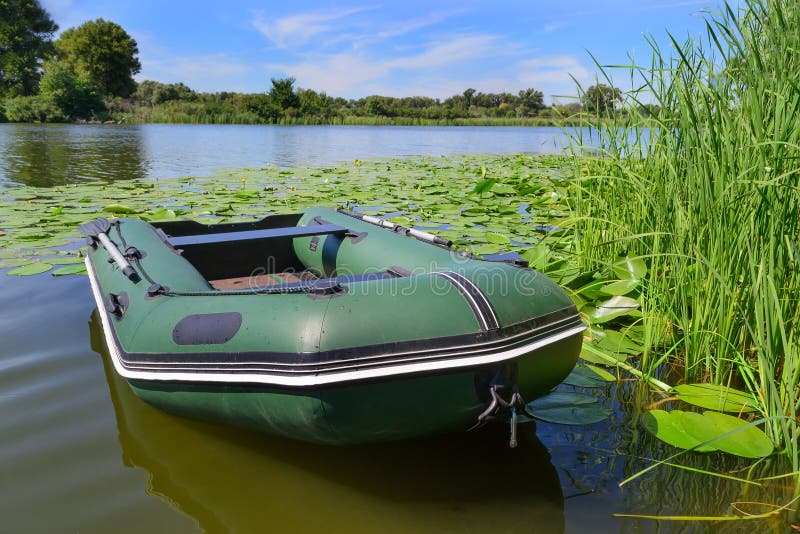 Inflatable boat stock image. Image of outboard, green - 67805311