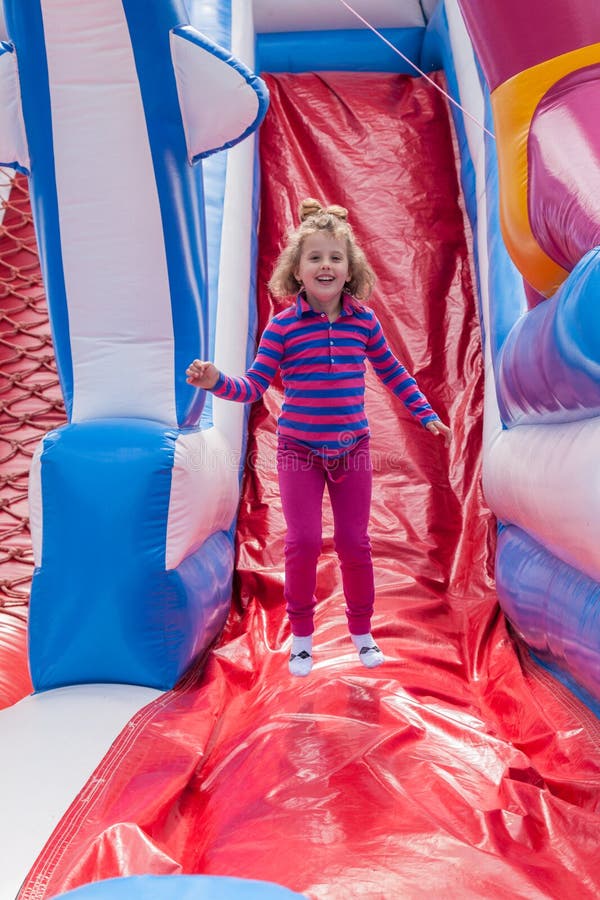 Boy Playing on and Inflatable Slide Stock Photo - Image of laughter ...