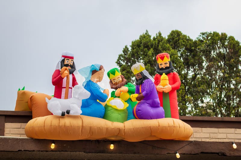 Inflatable Nativity Scene on a Rooftop with Trees in the Background ...