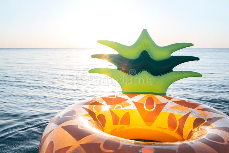 Inflatable Pineapple Floating in Sea. Close Up Shot of Rubber Ring with ...