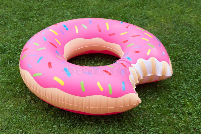 Inflatable Swim Ring in Shape of Donut on the Grass. Summer Vacations ...