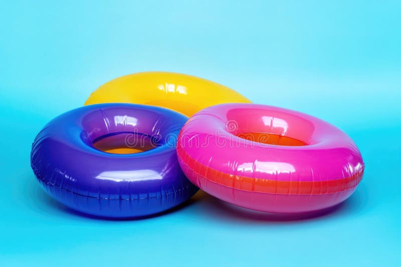 Inflatable Swimming Rings Floating on a Blue Background Stock ...