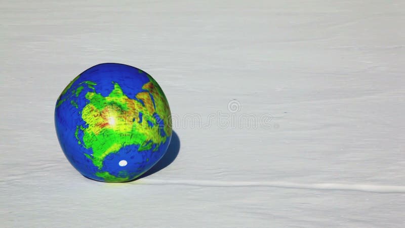 Inflated Ball with Earth Texture Roll by Snow at Stock Video - Video of ...