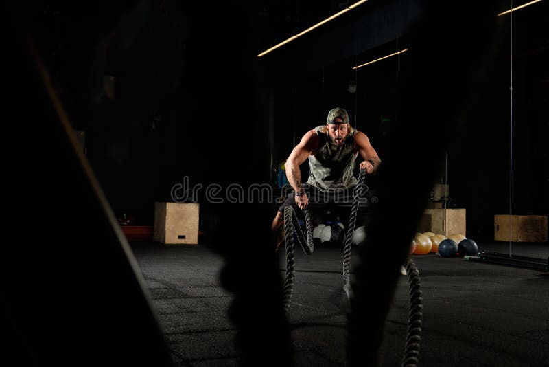 Inflated Man Performs an Exercise with Ropes, View from the Side of the ...