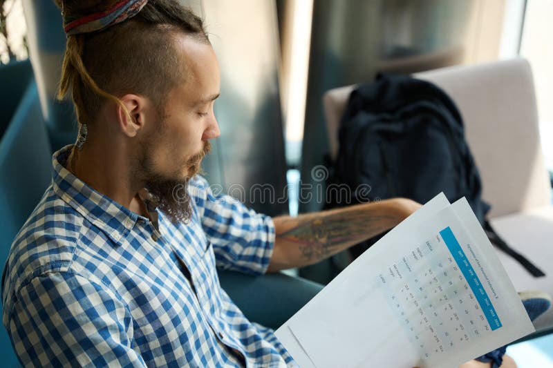 Informal Guy Studies Working Documents in a Coworking Space Stock Photo ...