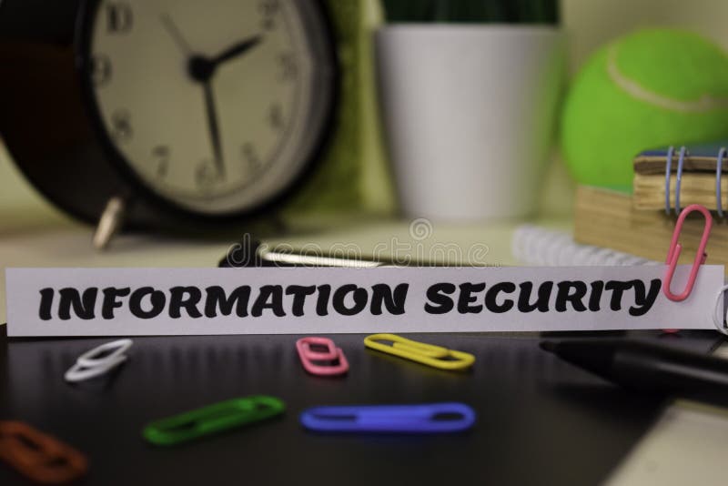 Information Security on the Paper Isolated on it Desk. Business and ...
