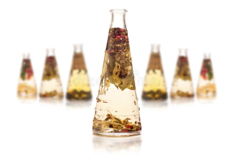 Infused Oils with Herbs and Spices in Elegant Glass Bottles on Kitchen ...