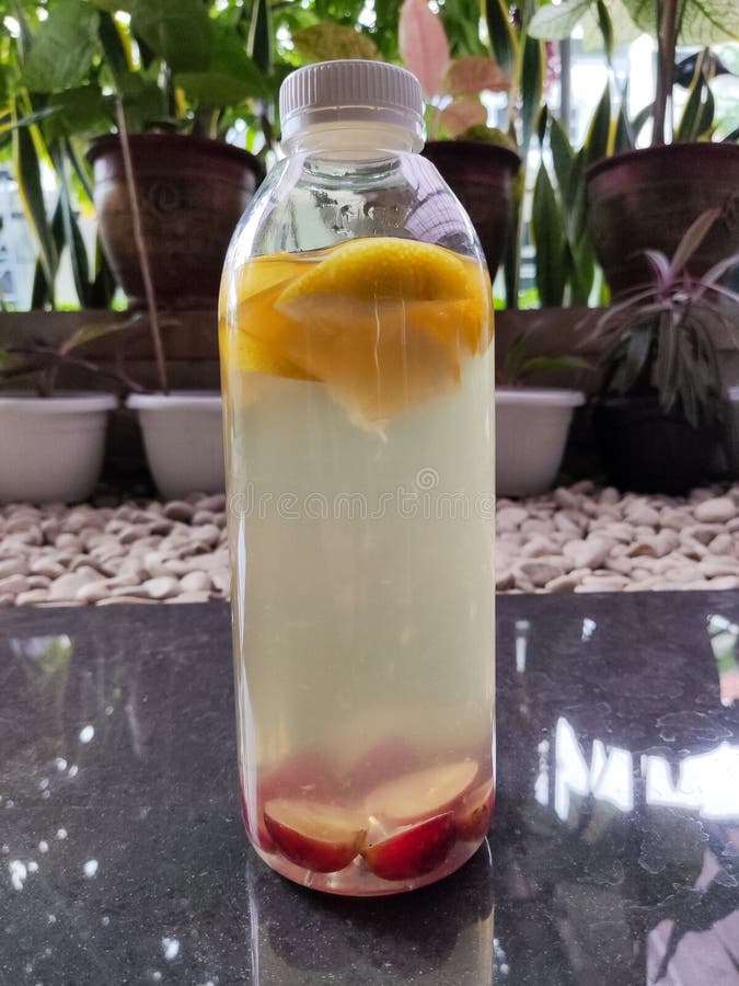 Infused Water Bottle with Lemon and Grape Stock Photo - Image of water ...