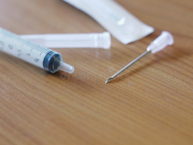 Injection Needle Syringe Unpack on Wooden Table Stock Image - Image of ...
