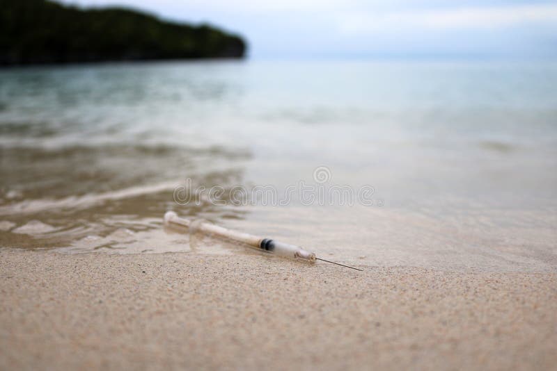 Injection Needles on the Beach. Stock Photo - Image of discarded ...