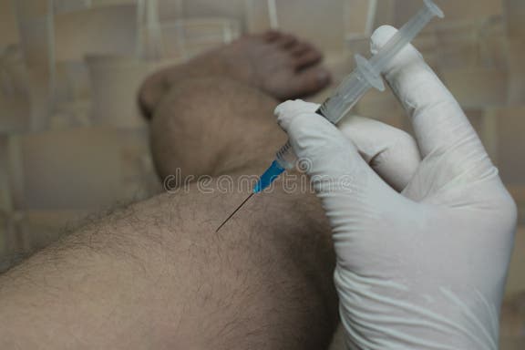 Injection of a Syringe into the Muscle of the Thigh Stock Image - Image ...