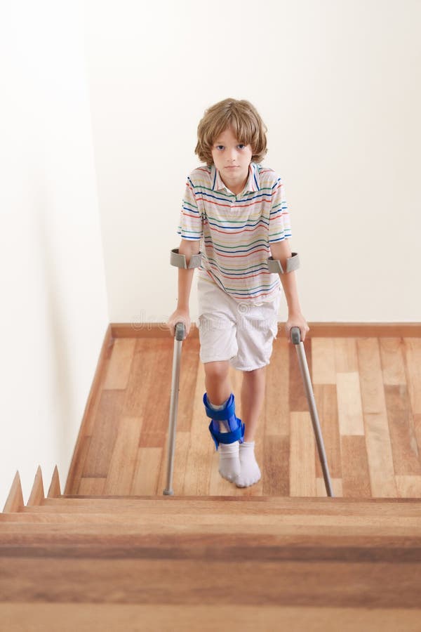 Injured Child on Crutches. Boy in Cast on Foot Stock Image - Image of ...