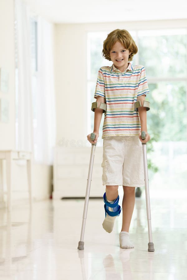 Injured Child on Crutches. Boy in Cast on Foot Stock Photo - Image of ...