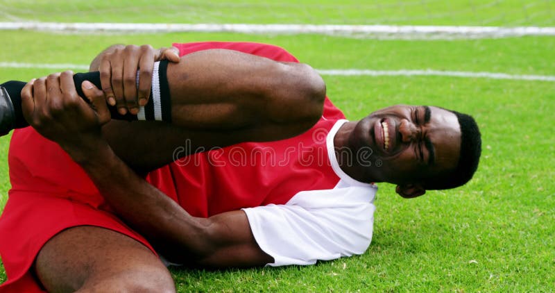 Injured Football Player Lying on Grass in the Field Stock Photo - Image ...