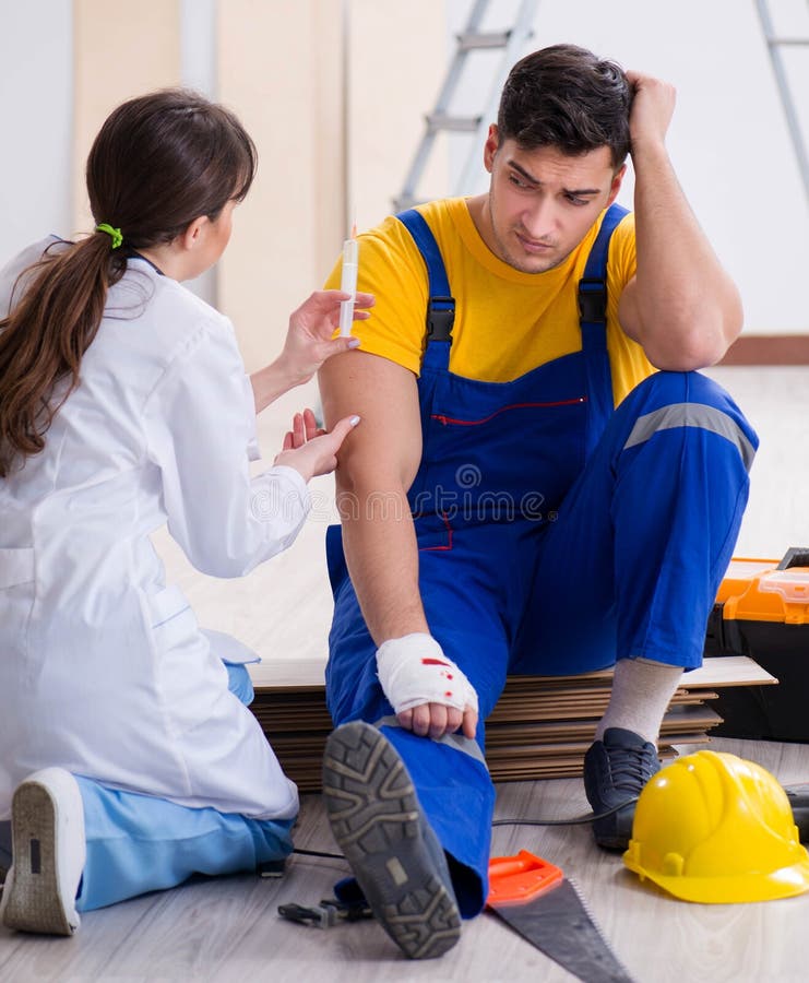 Injured Worker Being Assisted by Doctor Stock Photo - Image of ...