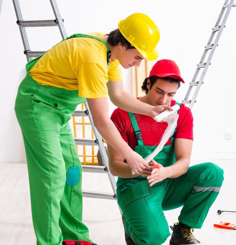 Injured Worker and His Workmate Stock Image - Image of building ...