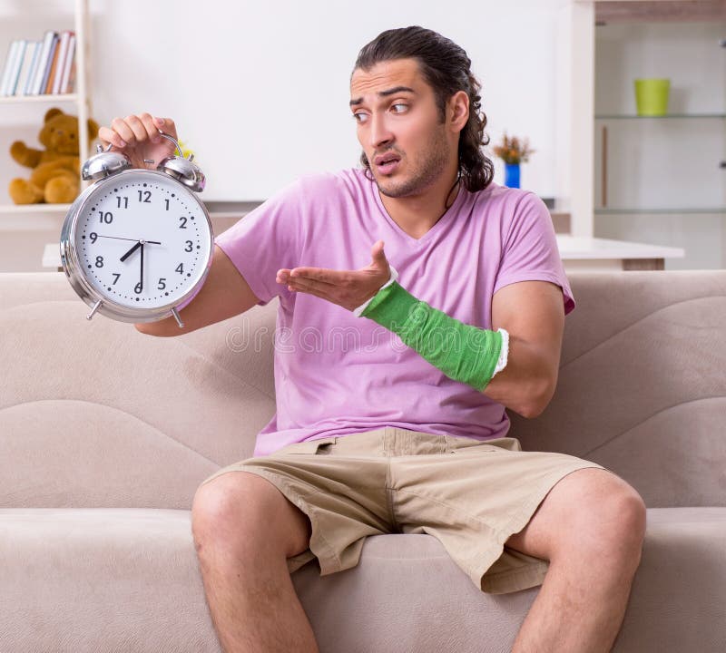 Injured young man at home stock photo. Image of late - 296459428