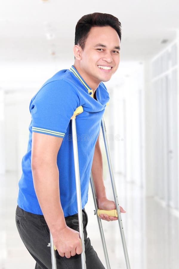 Injured Young Man Walking with the Help of Crutches Stock Image - Image ...