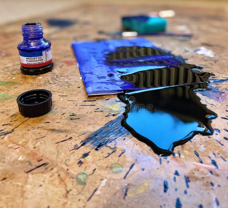 Blue Ink Stain Spilled on the Worktop with Spilled Paper and Open ...