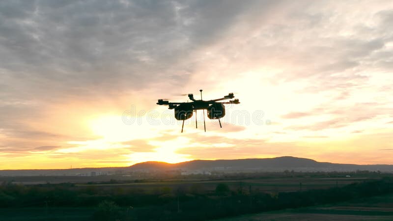 Autonomous Drones Fly Over Vast Agricultural Fields at Sunset ...