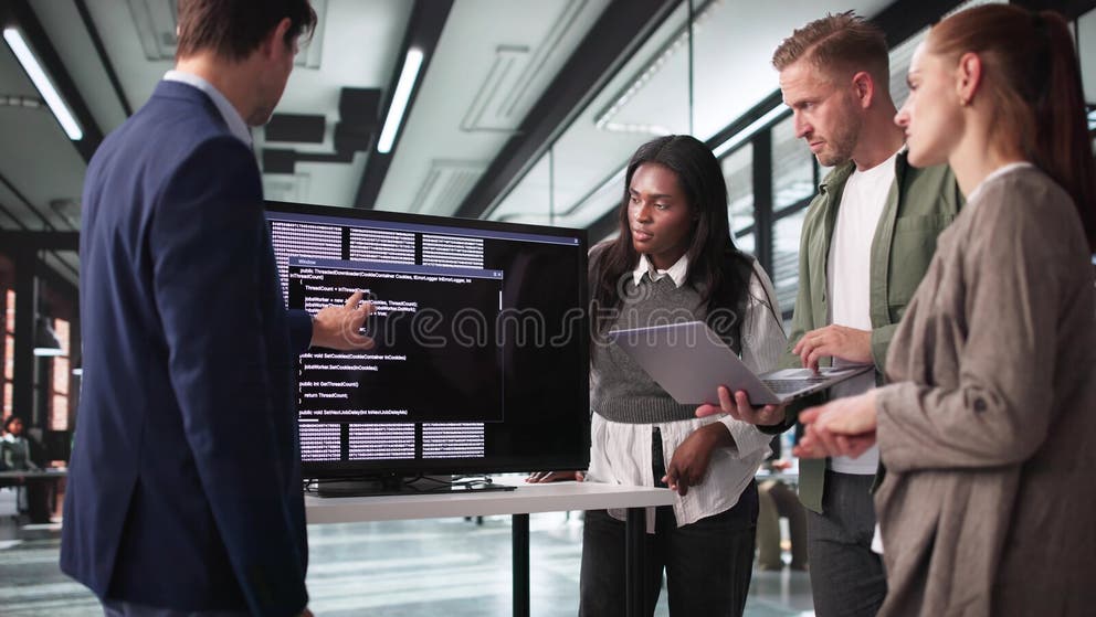 Innovative Developer Guides Team through Coding Presentation Stock ...