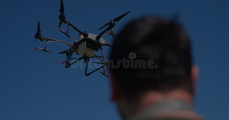 An Innovative Farmer Operates a Drone while Standing in the Middle of a ...