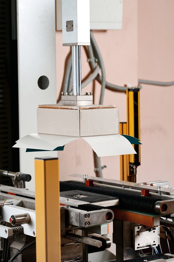 Innovative Machine Expertly Wrapping Rectangular Boxes in a Busy ...