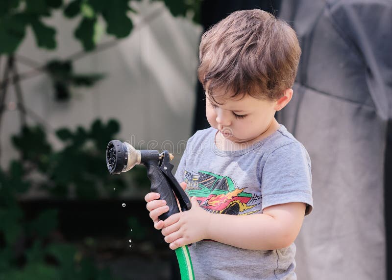 Inquisitive Toddler is Exploring Objects in the Backyard Stock Image ...