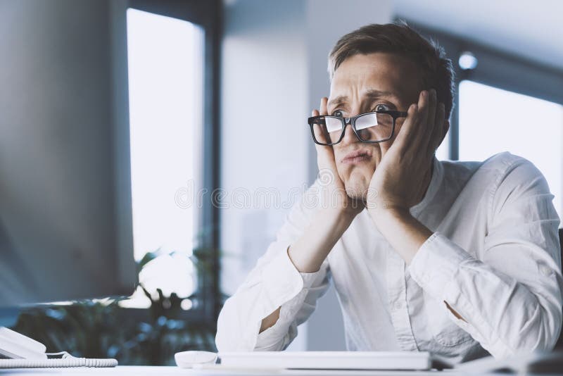 Insane Stressed Office Worker Sitting at Desk with Head in Hands Stock ...
