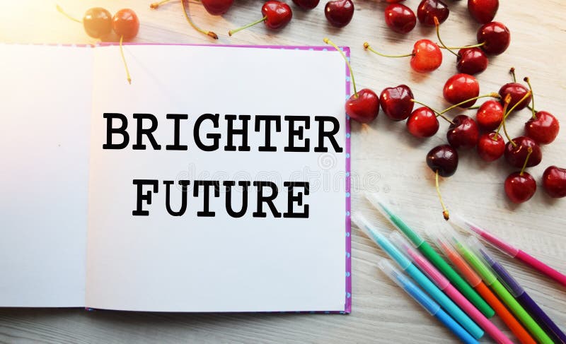 The Inscription BRIGHTER FUTURE in a Notebook. View of the Table Along ... The Inscription BRIGHTER FUTURE in a Notebook. View of the Table Along ...
