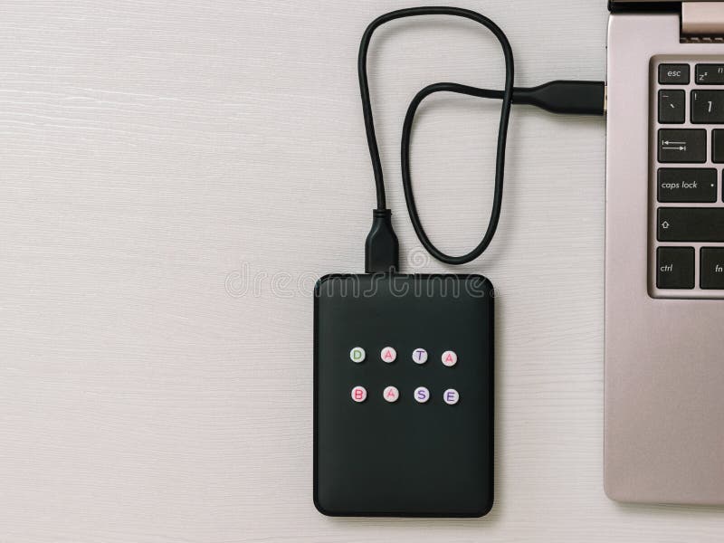 Laptop with External Hard Drive Labeled Database on the Table. Flat Lay ...
