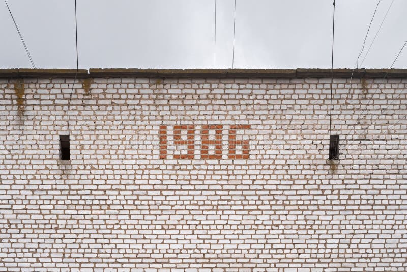 The Inscription 1986 is Laid Out of Bricks on the Wall of an Old Soviet ...