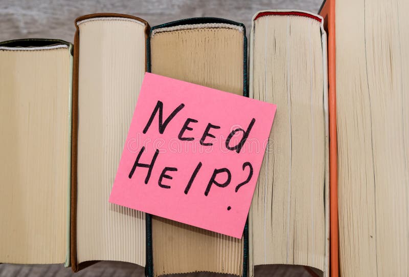 The Inscription Need Help on the Background of a Stack of Books. Close ...