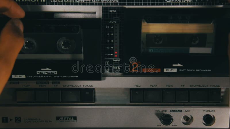 Insert an Audio Cassette into a Tape Player and Playback Stock Footage ...