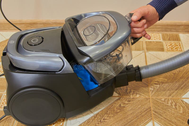 Insert a Clean Container into the Vacuum Cleaner, a Man Installs a ...