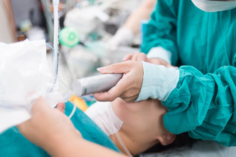 A Team of Urologist Doctors Performing a Cystoscopy Using a Cystoscope ...