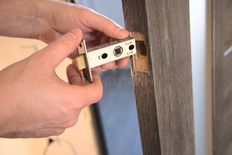 Insert of Latch and Handle into the Interior Door. Close-up View of the ...