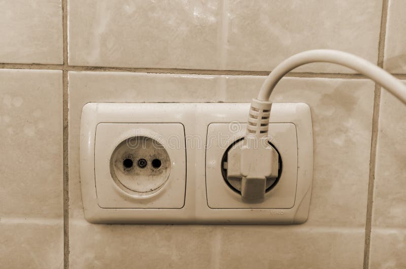 Insert the Plug into a Power Outlet. Socket in the Wall. Close-up ...