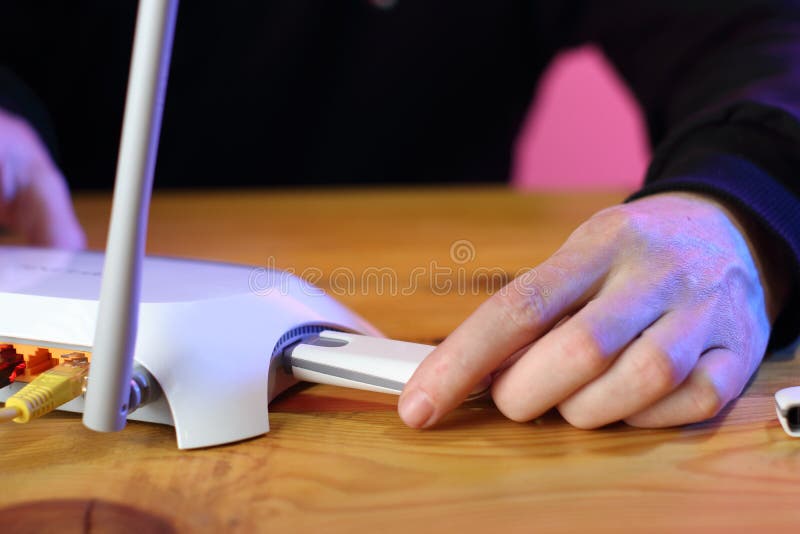 Inserting the Gsm Modem into the Router on the Table by the Person ...
