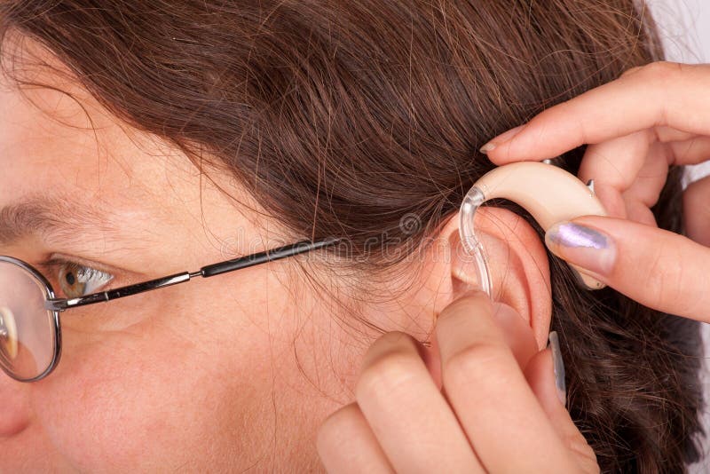 Inserting a hearin aid stock image. Image of practitioner - 75346809